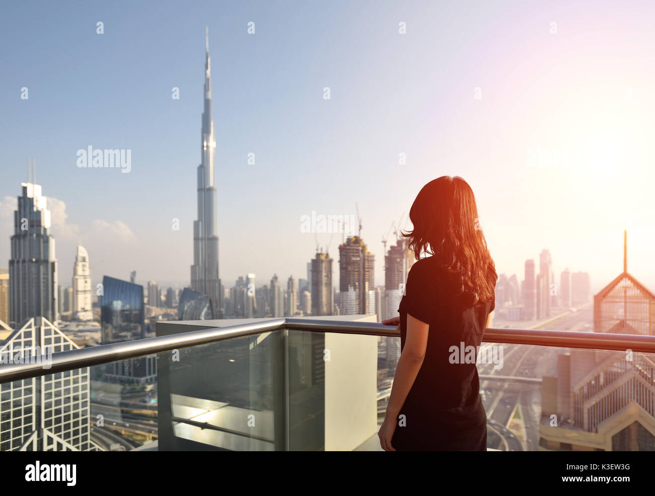 Asian woman overlooking the cityscape of Dubai Stock Photo - Alamy