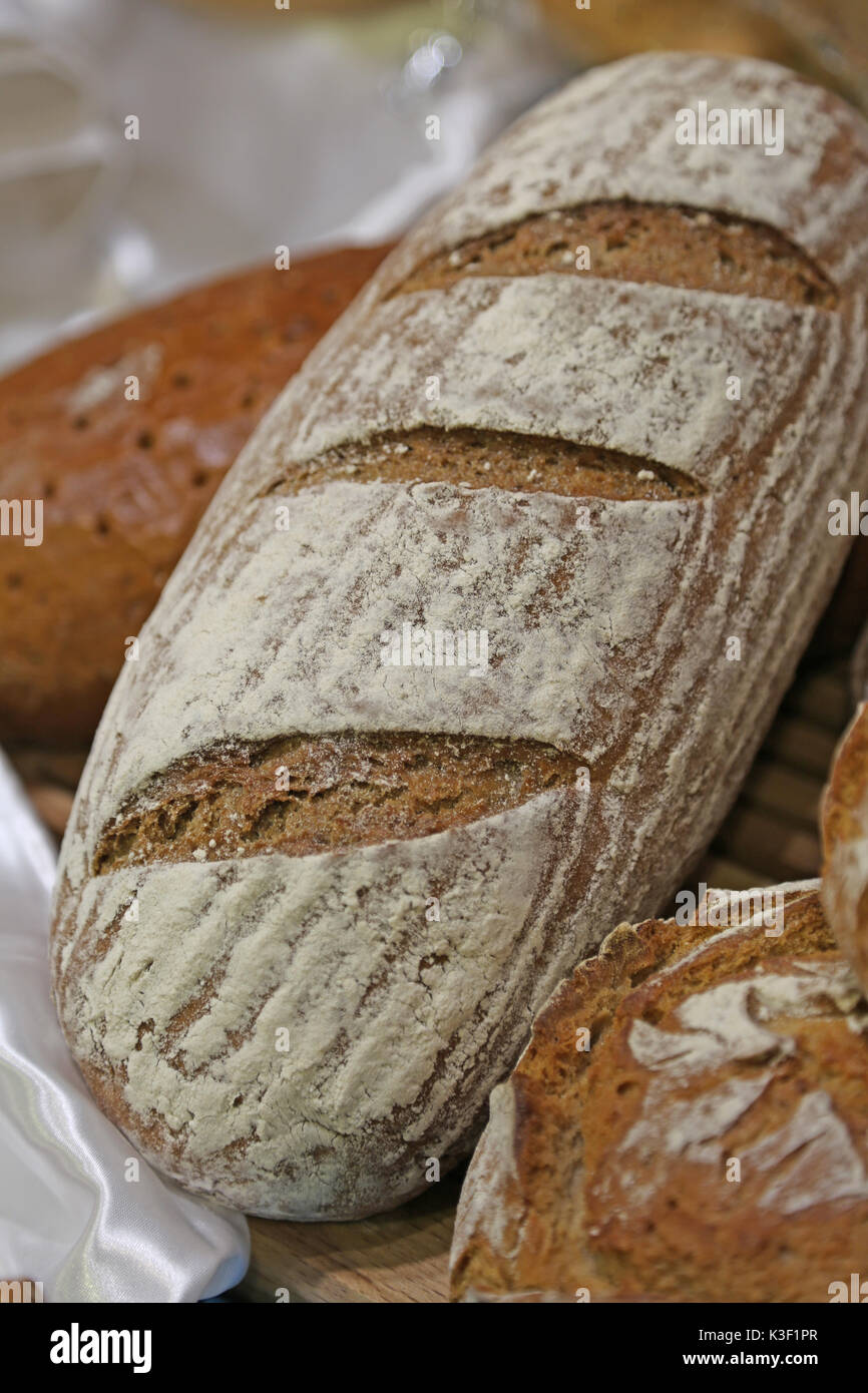many pieces of fresh bread in the bakery with fragrant loaves and ...