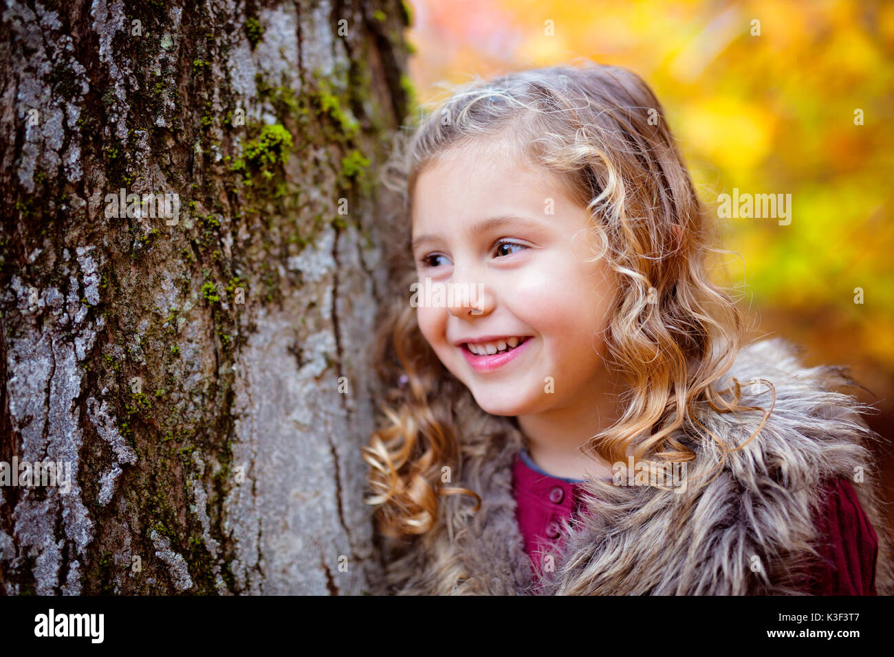 Adorable little girl in a autumn forest Stock Photo - Alamy