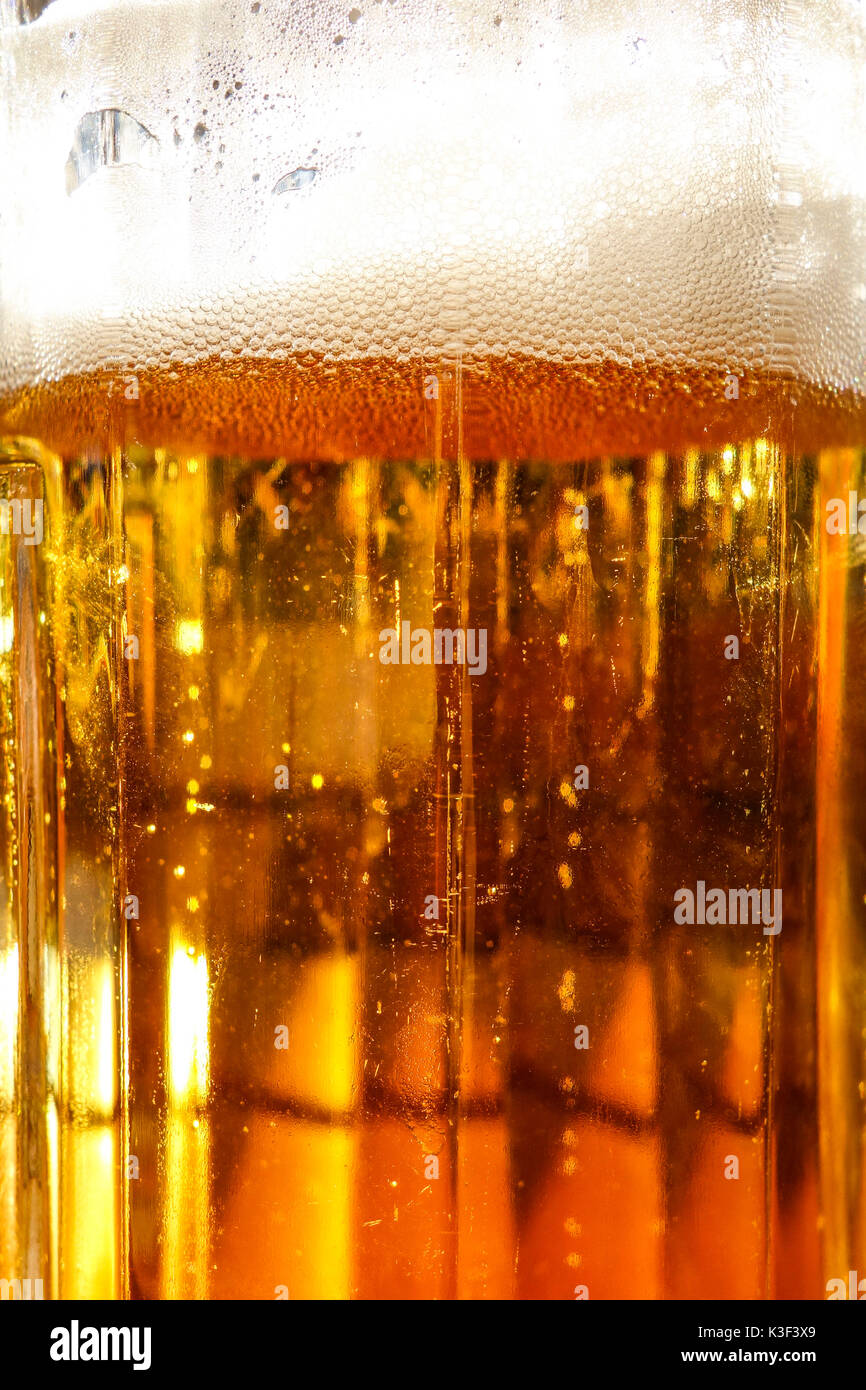 Fresh tapped glass of beer, light, close up Stock Photo - Alamy