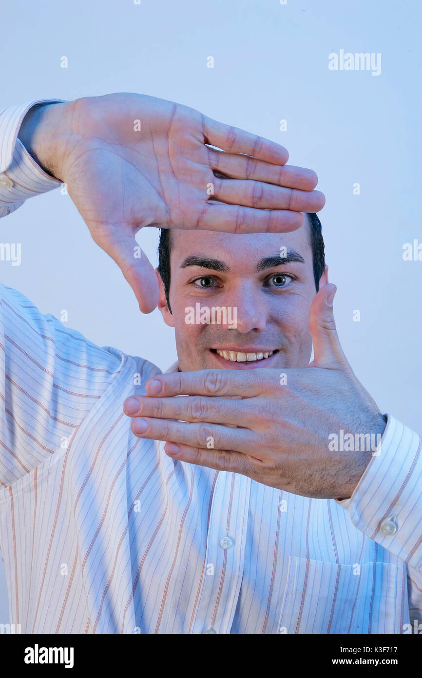 Man forms a rectangle with his hands and looks through Stock Photo - Alamy
