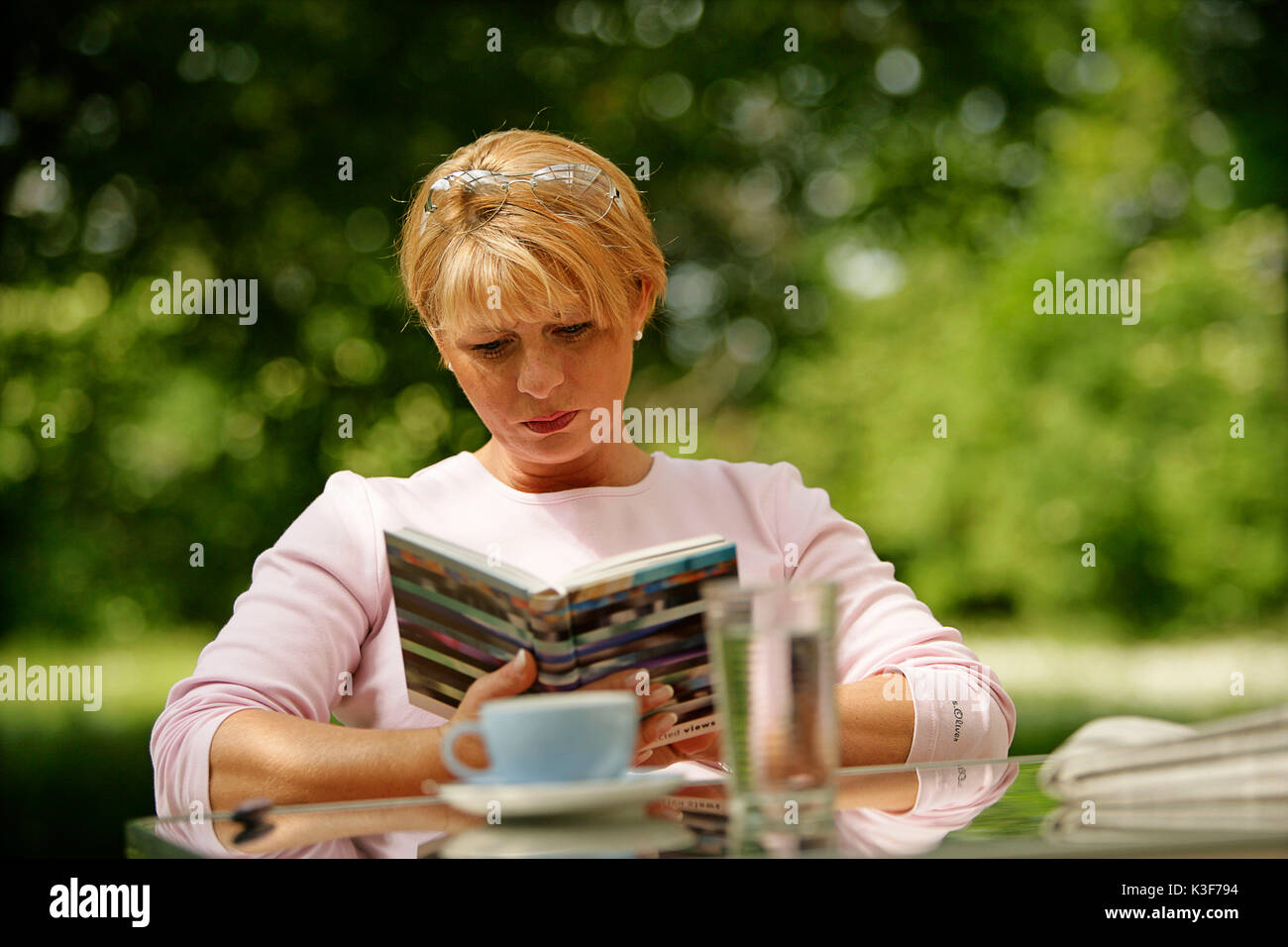 Woman reads book relaxing in hi-res stock photography and images - Alamy