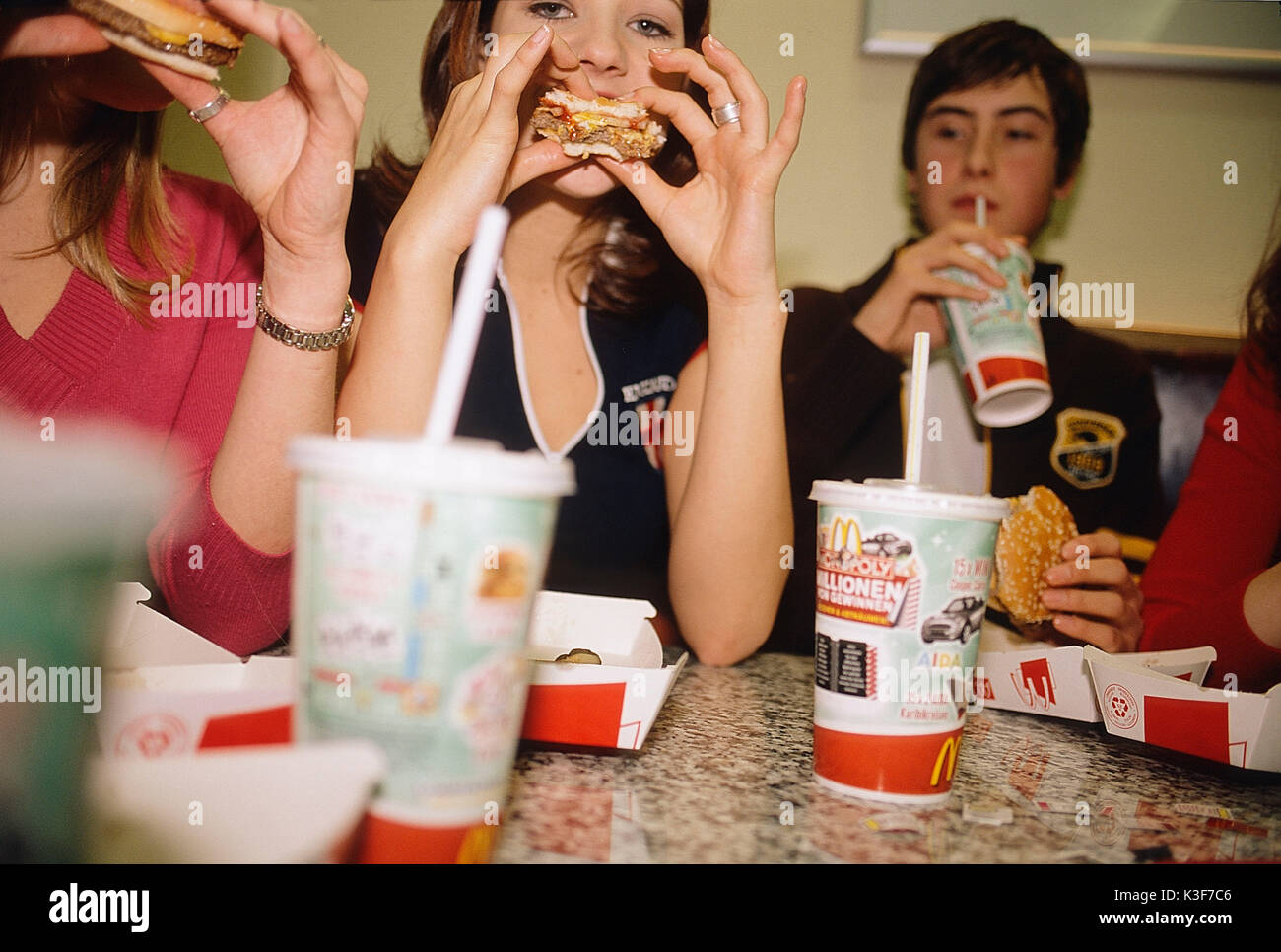Group of young persons in fast food restaurant Stock Photo - Alamy