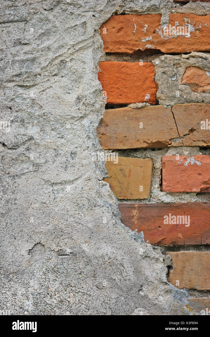Red bricks stone wall background closeup, cracked ruined stucco ...