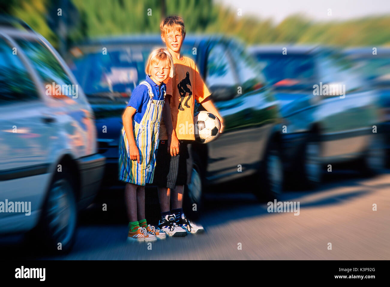 Boy and girl want to cross the street Stock Photo - Alamy