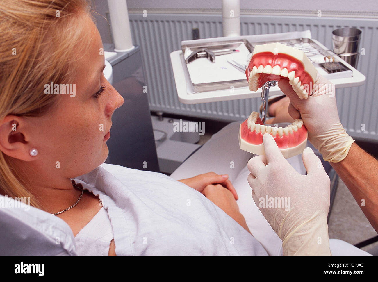Dentist declares tooth problems at the model to his patient Stock Photo ...