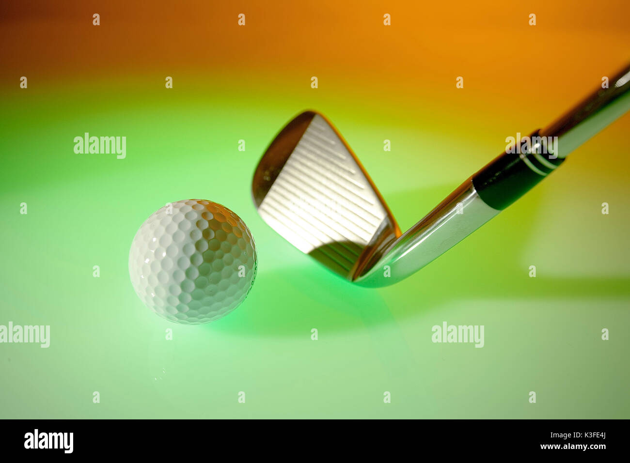 Golf ball and iron racquet Stock Photo - Alamy