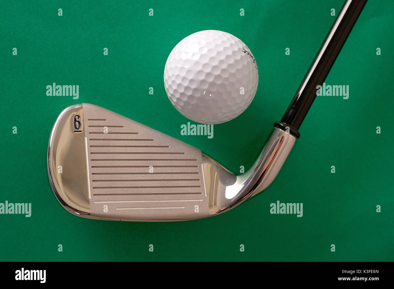 Golf ball and iron racquet Stock Photo - Alamy