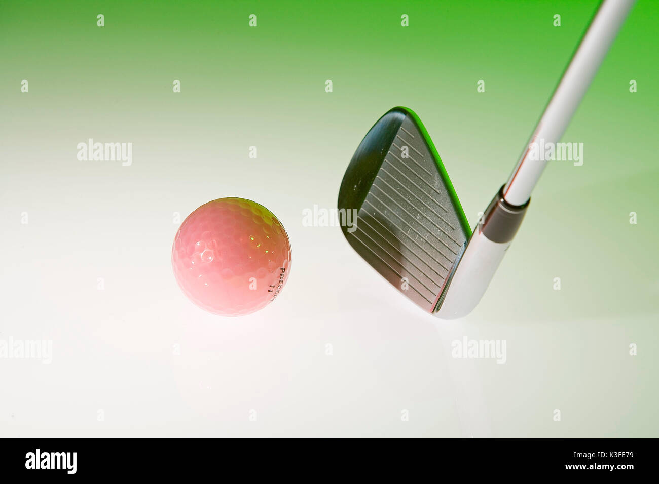 Golf ball and iron racquet Stock Photo - Alamy