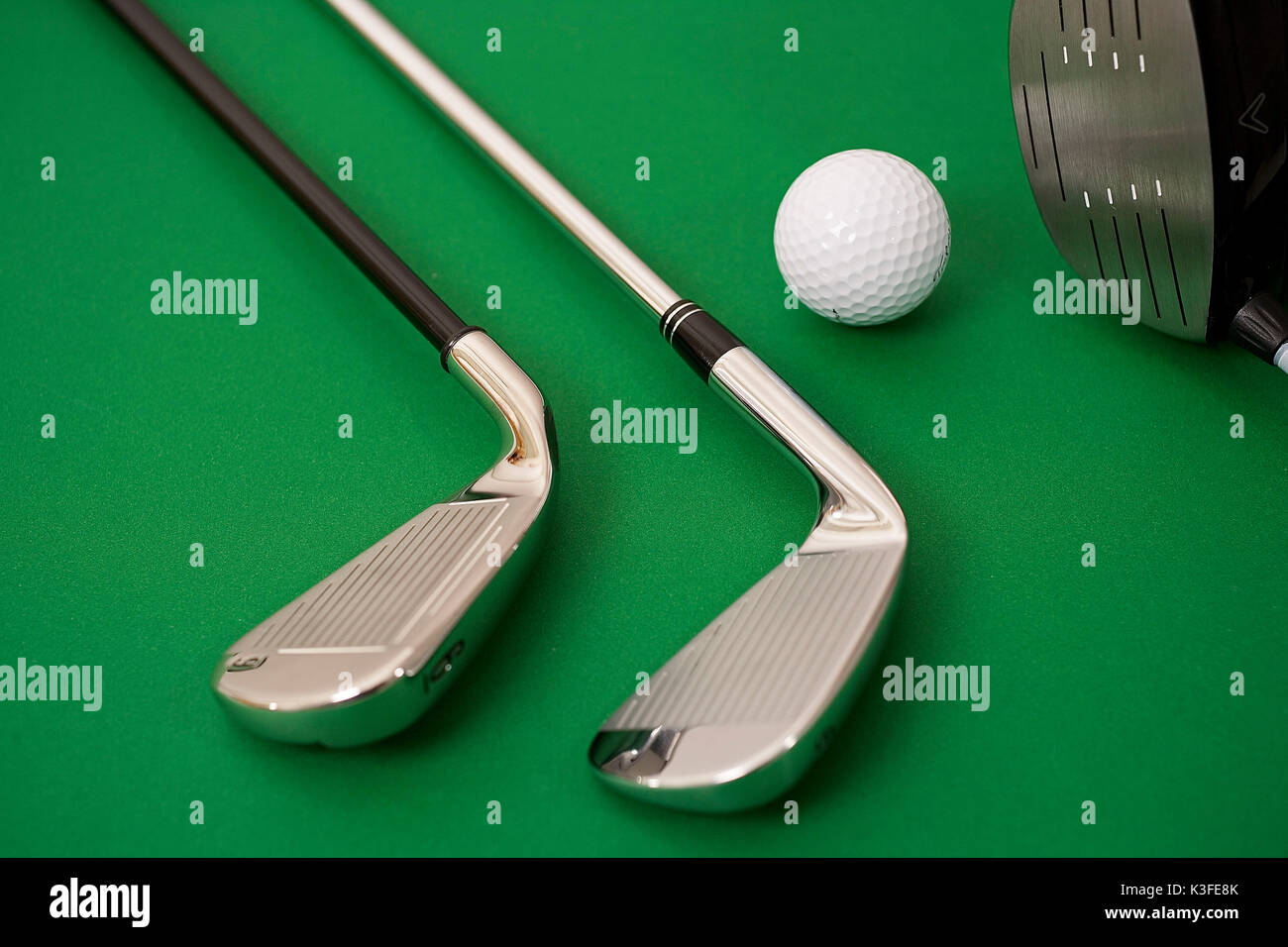 Golf ball and iron racquet Stock Photo - Alamy