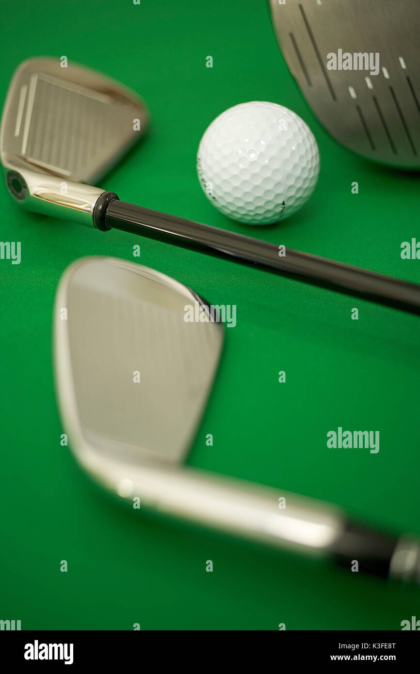 Golf ball and iron racquet Stock Photo - Alamy