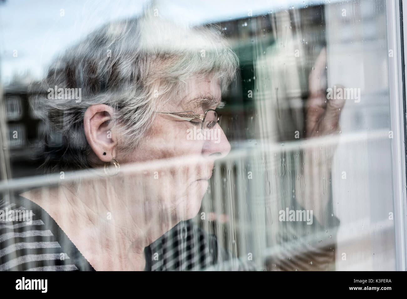 Old woman window dementia hi-res stock photography and images - Alamy