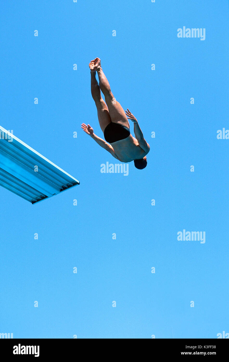 Tower jumper close the crack of the springboard Stock Photo - Alamy