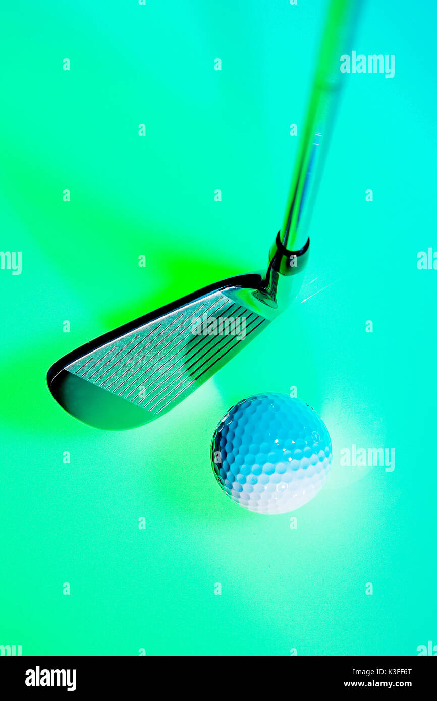 Golf ball and iron racquet Stock Photo - Alamy