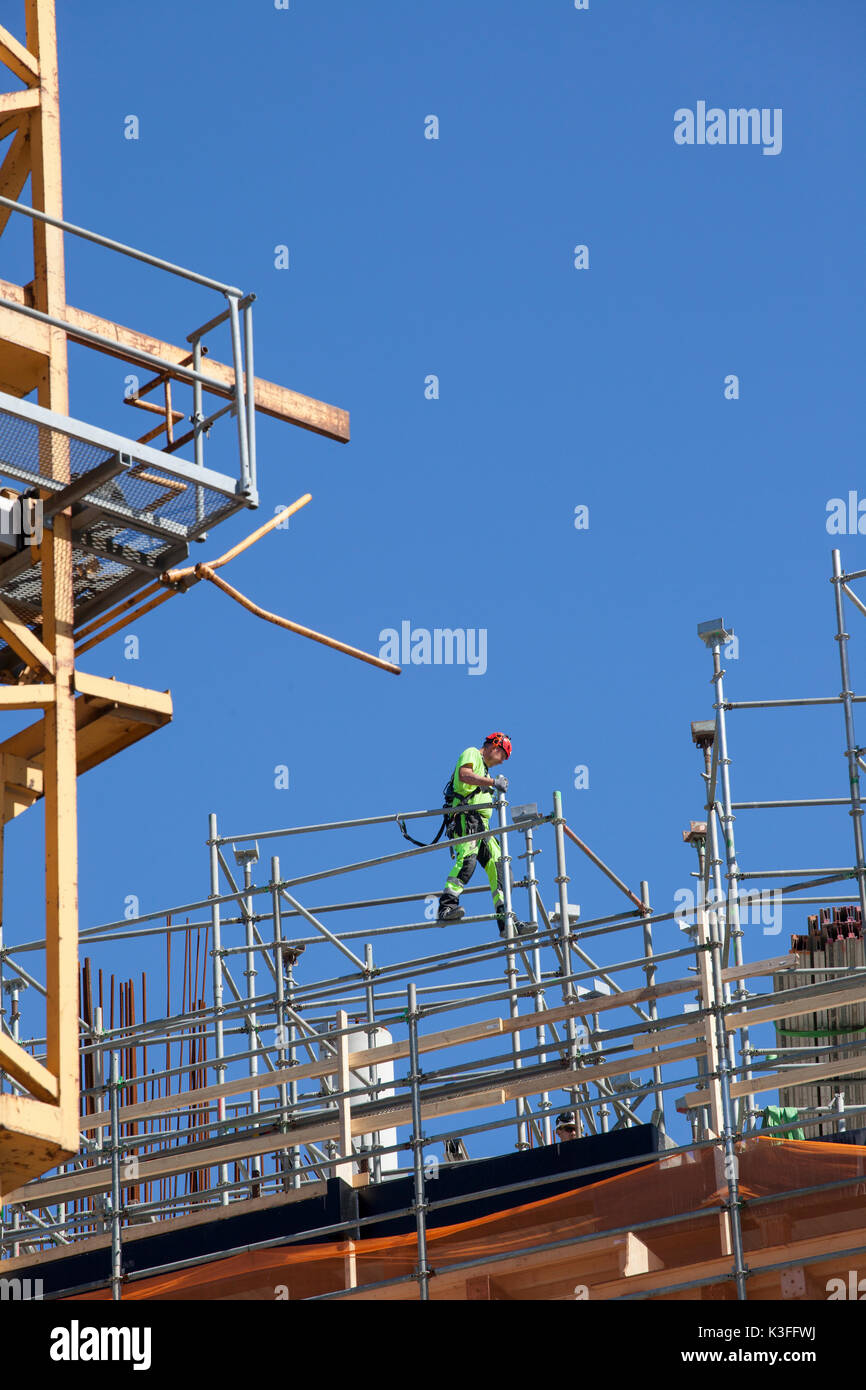consturction worker at work on building facade Stock Photo - Alamy