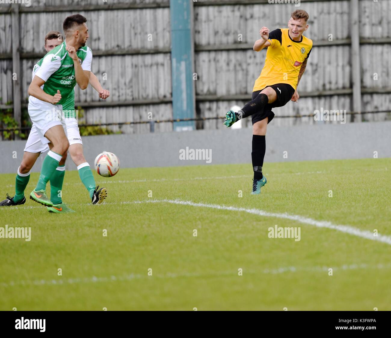 Football action from the non-league match between New Mills and Holker ...