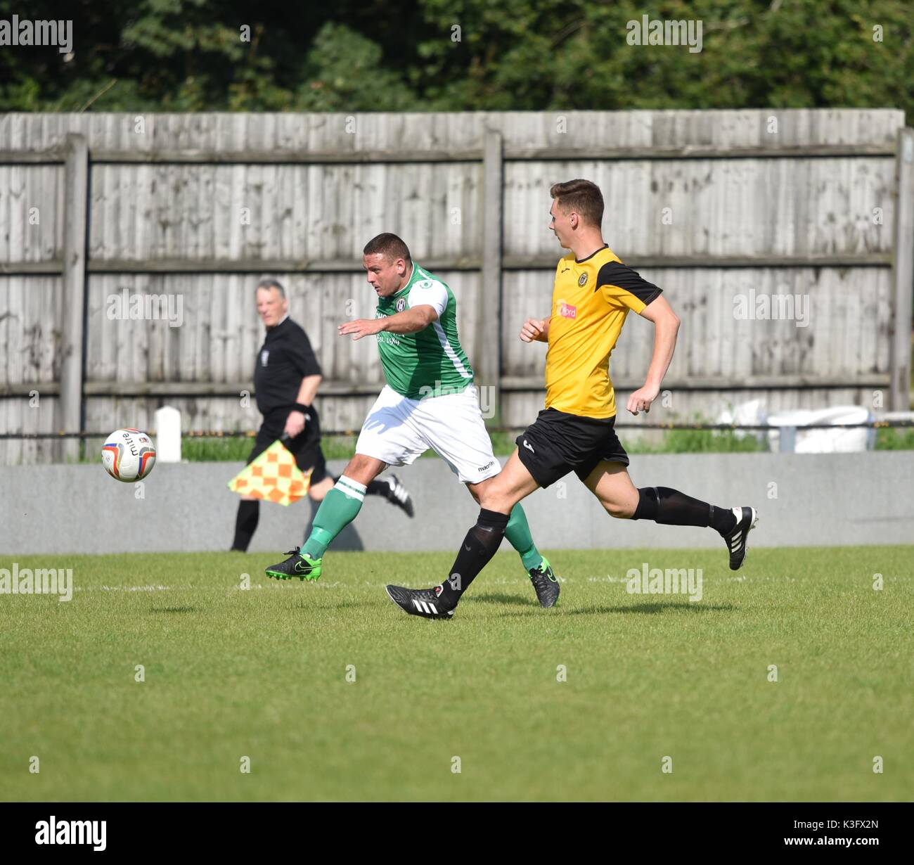 Football action from the non-league match between New Mills and Holker ...