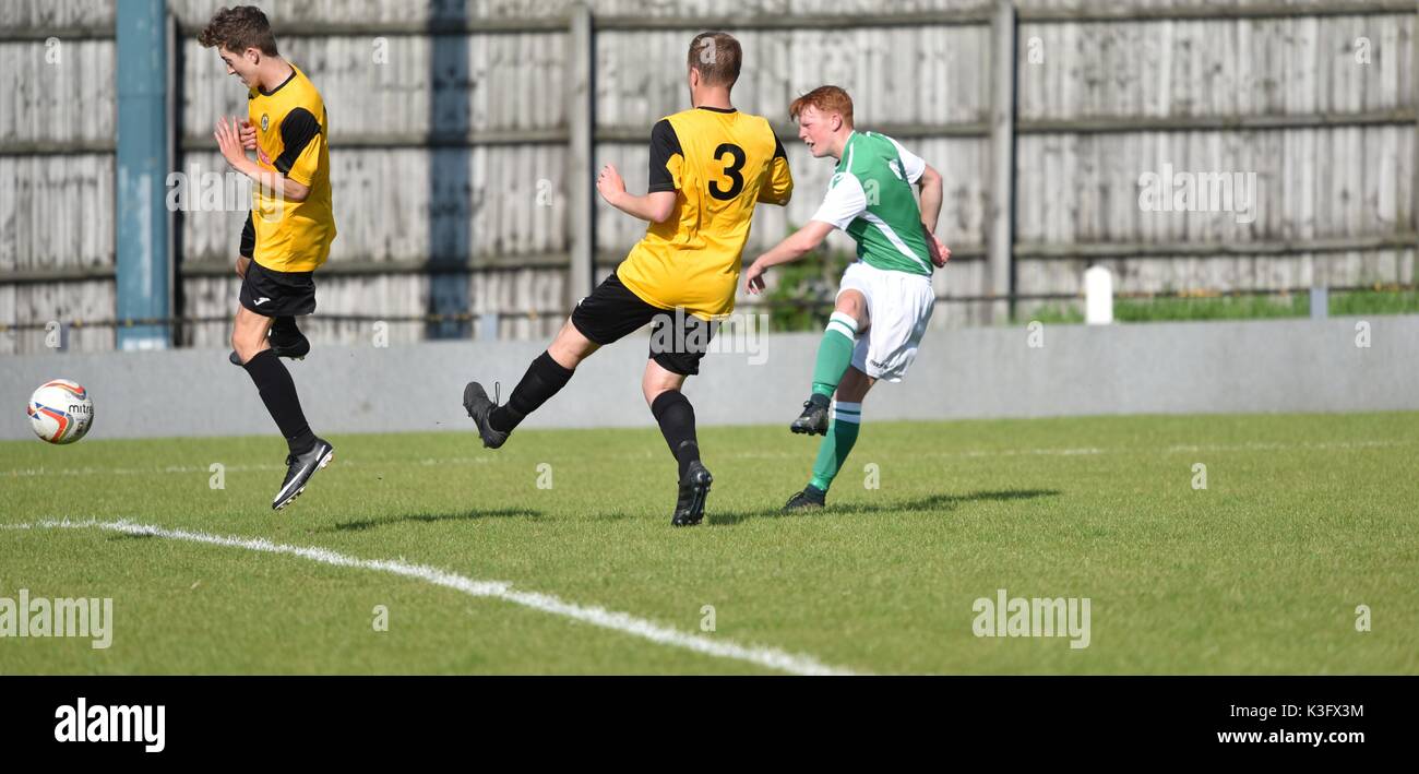 Football action from the non-league match between New Mills and Holker ...