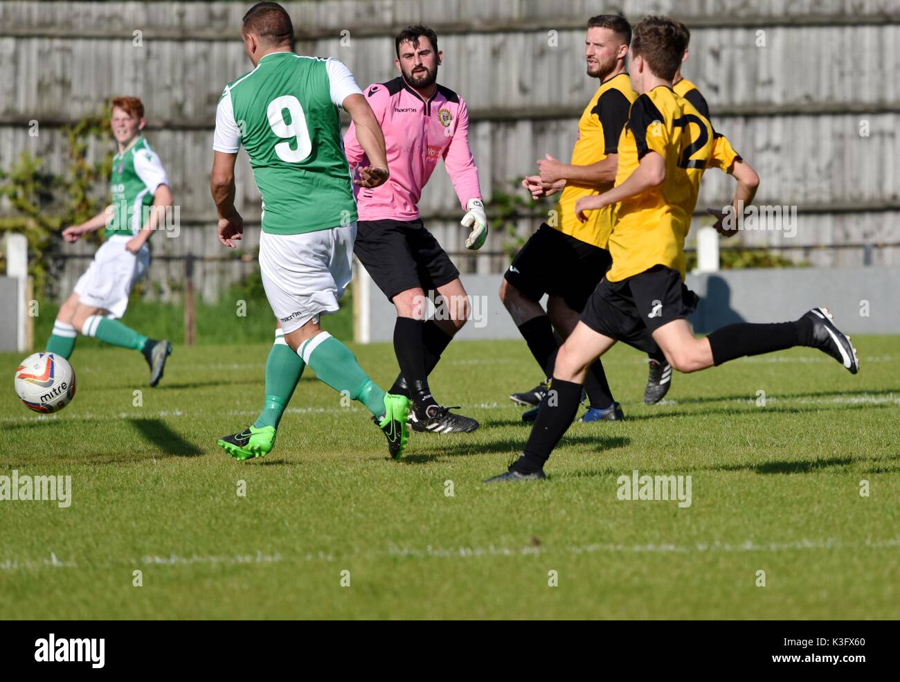 Football action from the non-league match between New Mills and Holker ...