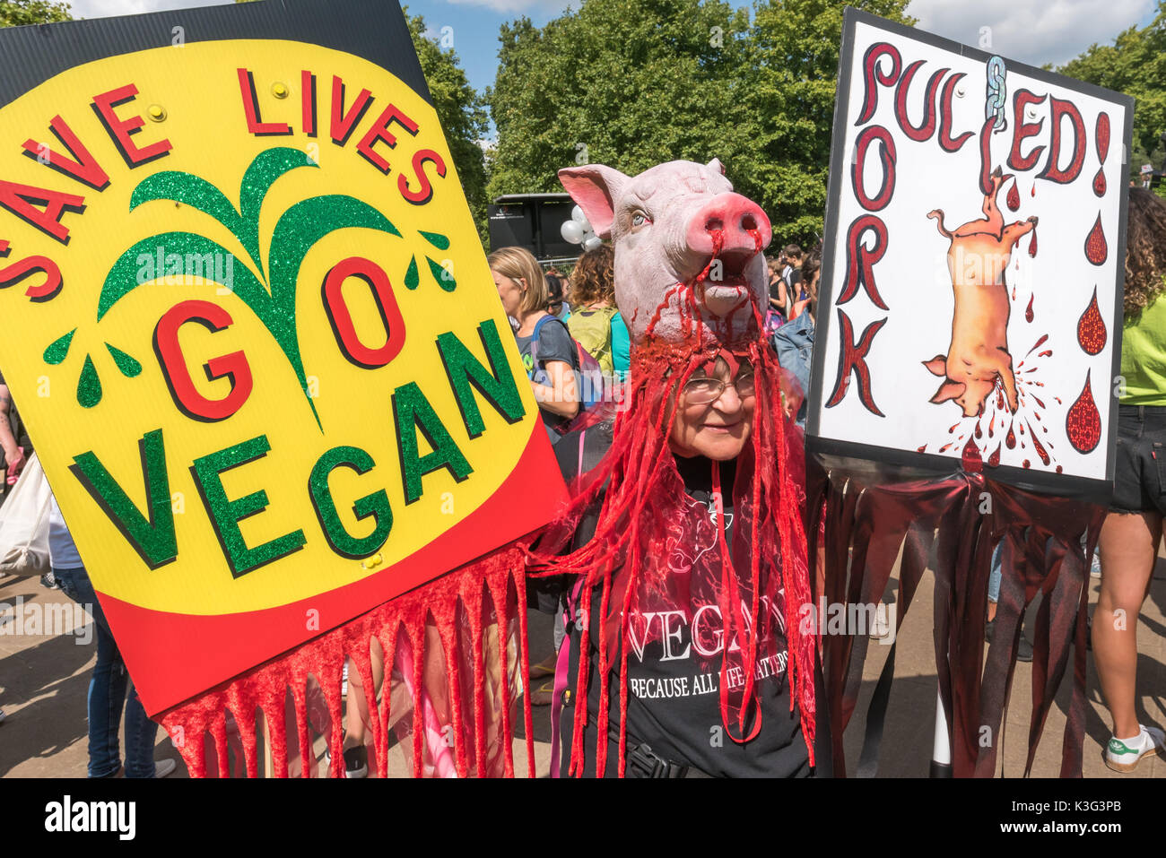London , UK. 2nd September 2017. A woman with a pigs head and vegan ...
