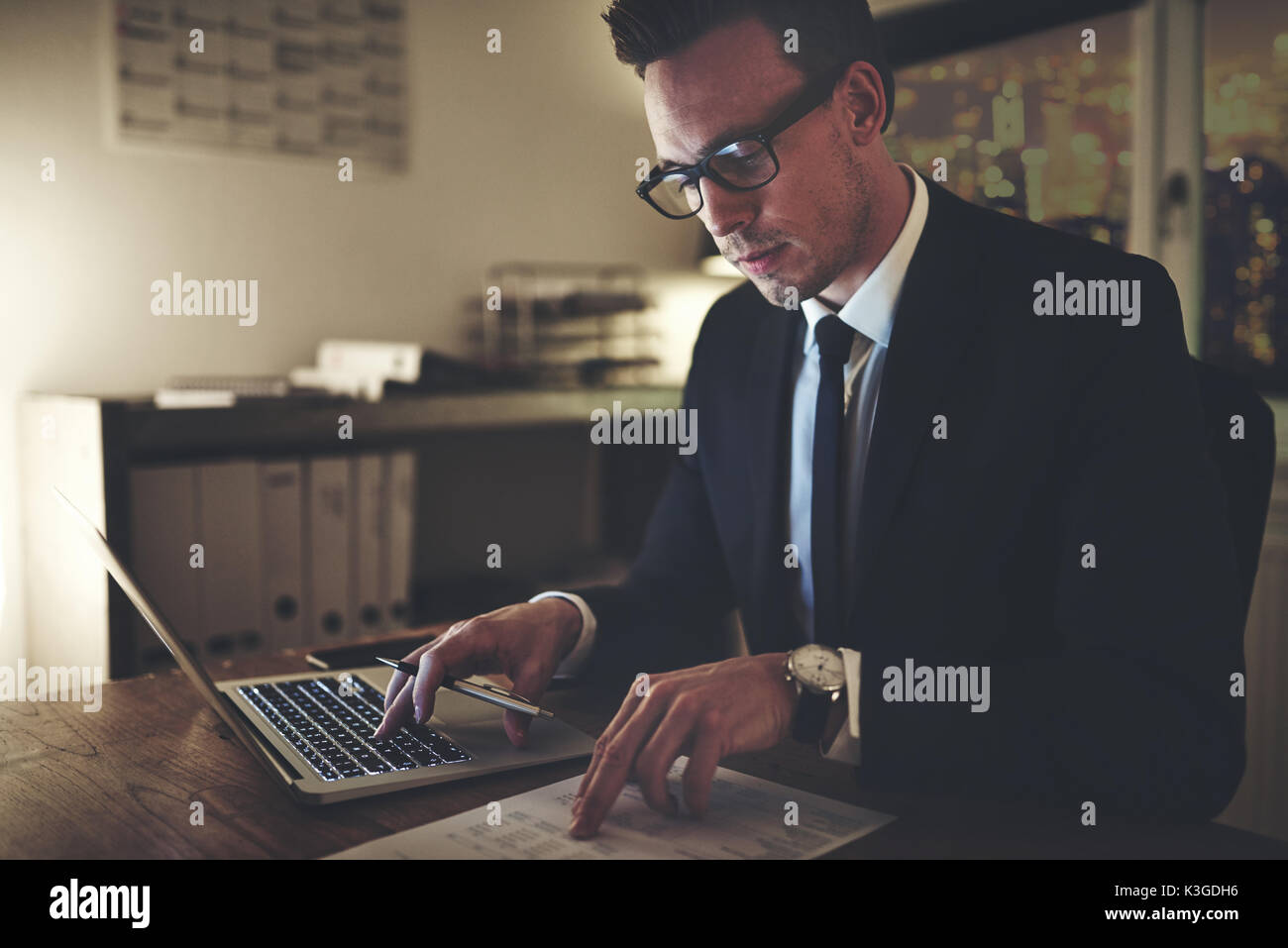 Serious business man working on documents looking concentrated with ...