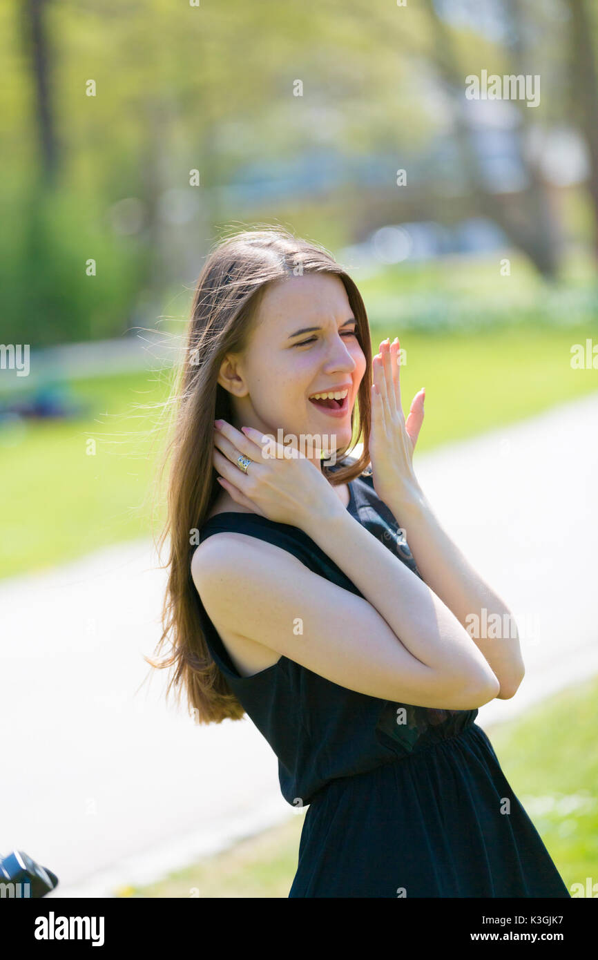 Brunette girl laughing covering mouth hi-res stock photography and ...