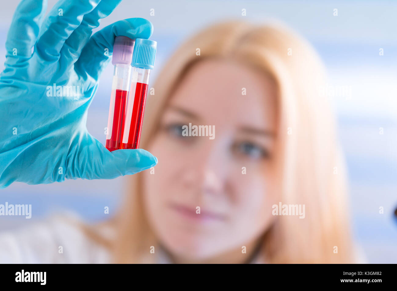 Woman researcher with a blood test in a laboratory Stock Photo - Alamy