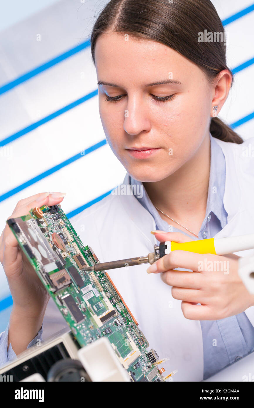 Young woman fix PC component in service center Stock Photo - Alamy