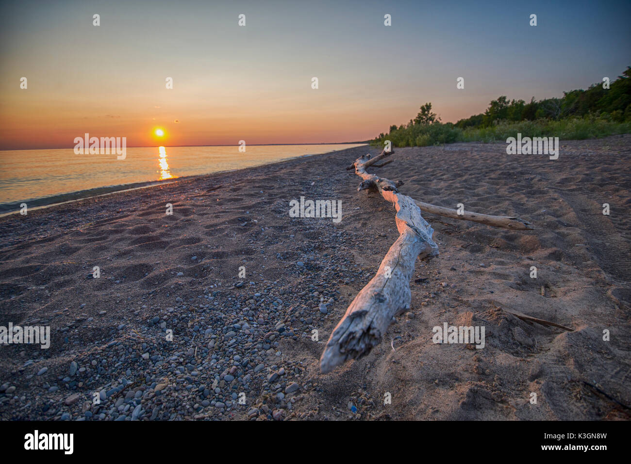 Beautiful sunset on lake erie beach with driftwood at Point Pelee ...