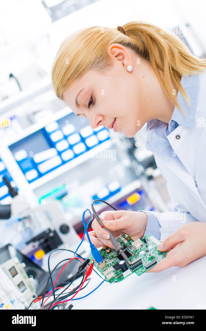 Female laboratory assistant Repairs PCB module for CNC robotics ...