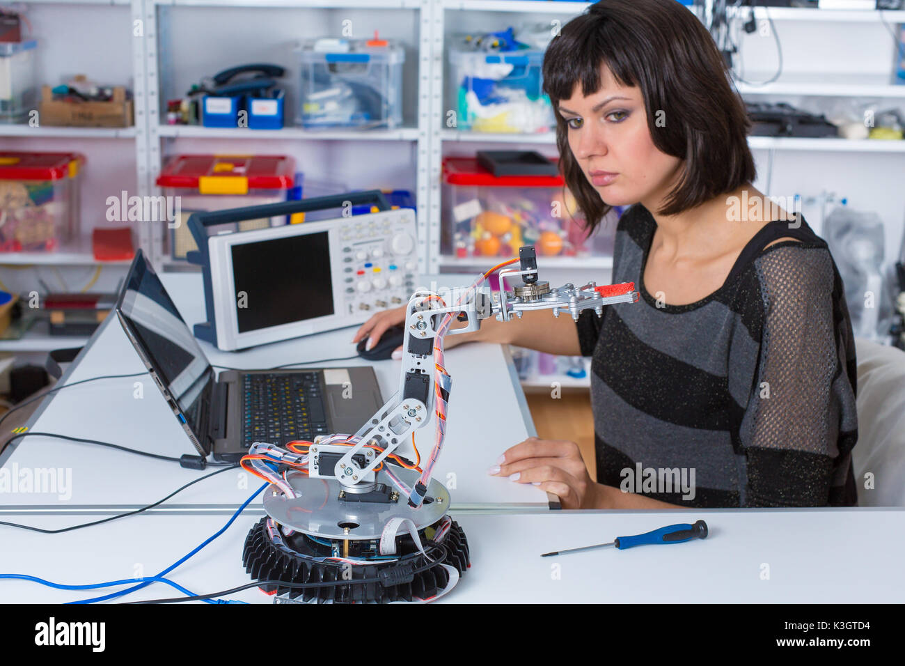 Female in robotics laboratory. Young woman experiment with robot Stock ...