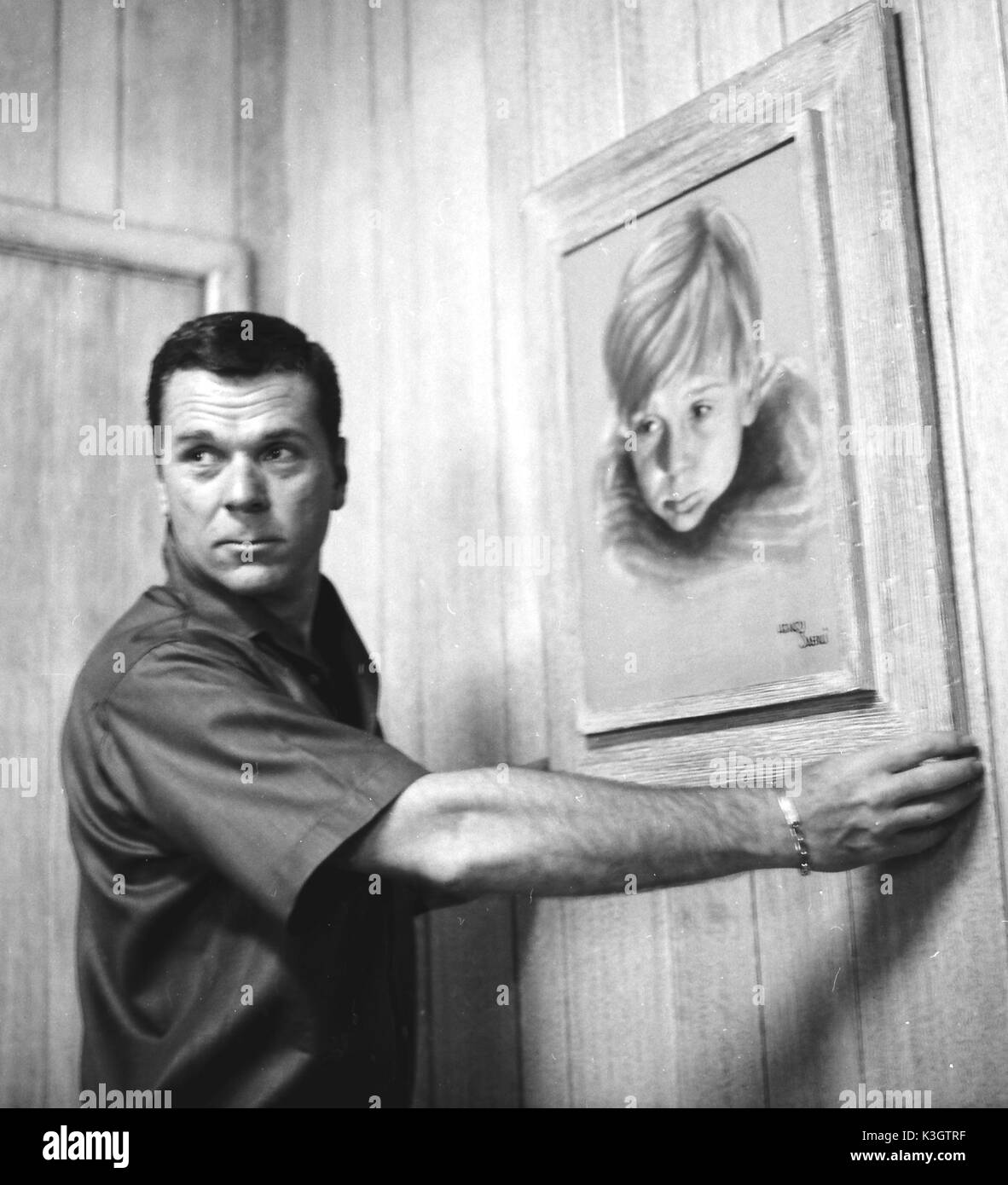JACKIE COOPER American actor, at home, with a painting of himself as a ...