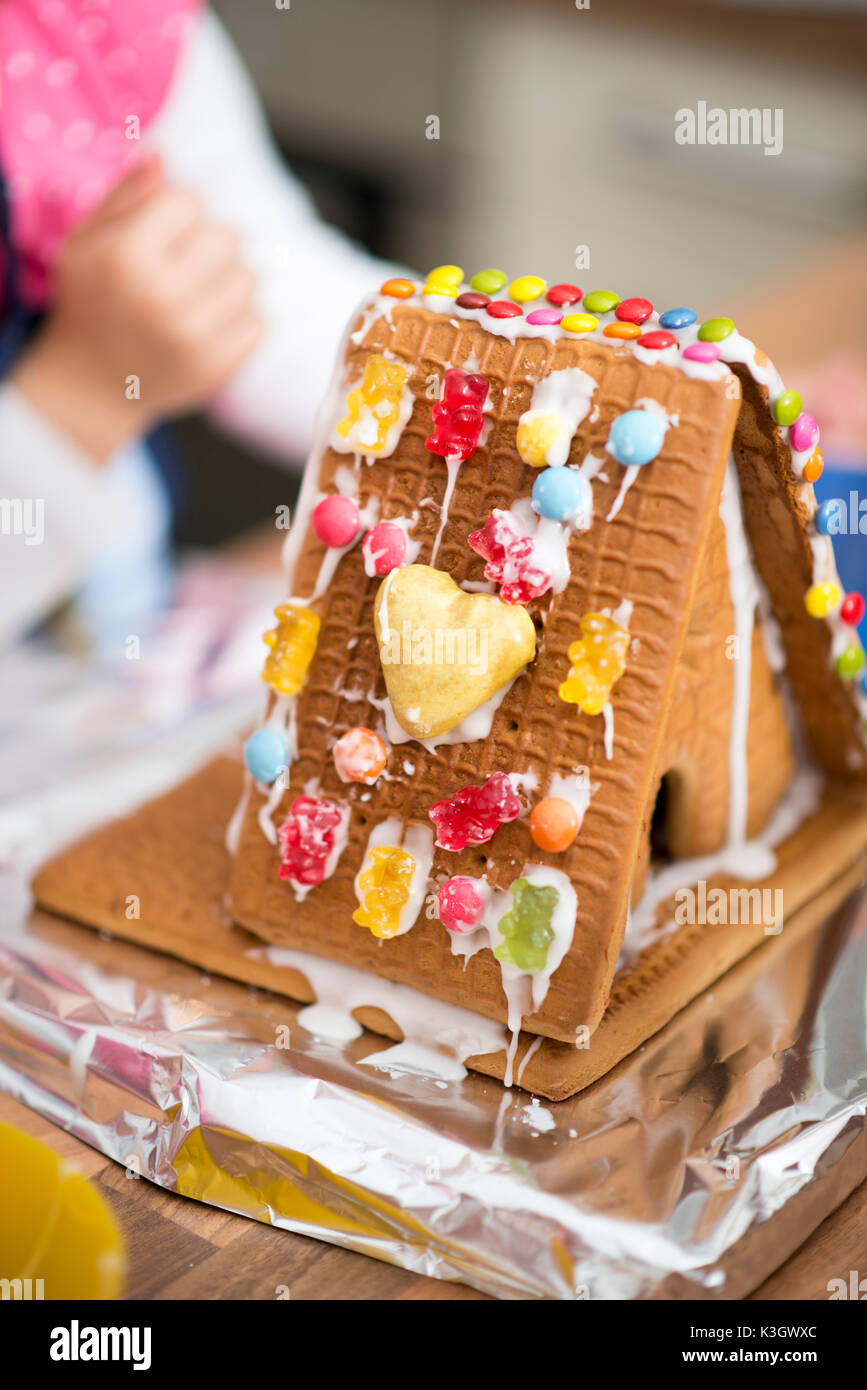 Family decorated with sweets a homemade gingerbread house Stock Photo ...