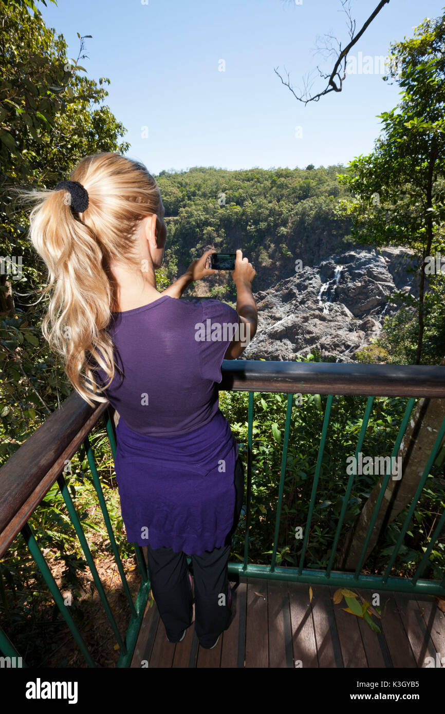 Tourist taking images of Barron Falls Waterfall, Kuranda, Cairns ...