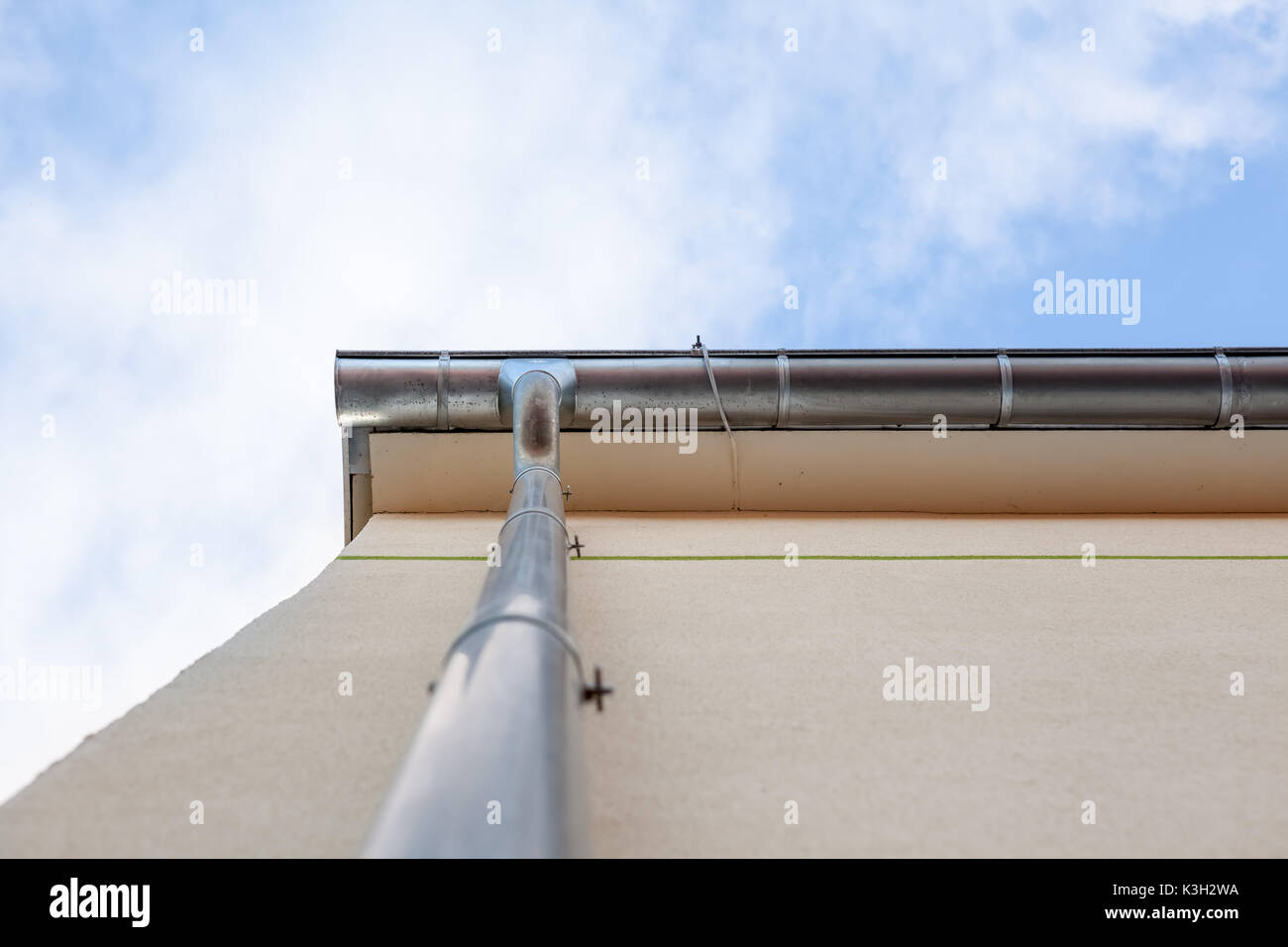 an rain drain pipe from the roof whit blue sky and clouds Stock Photo ...