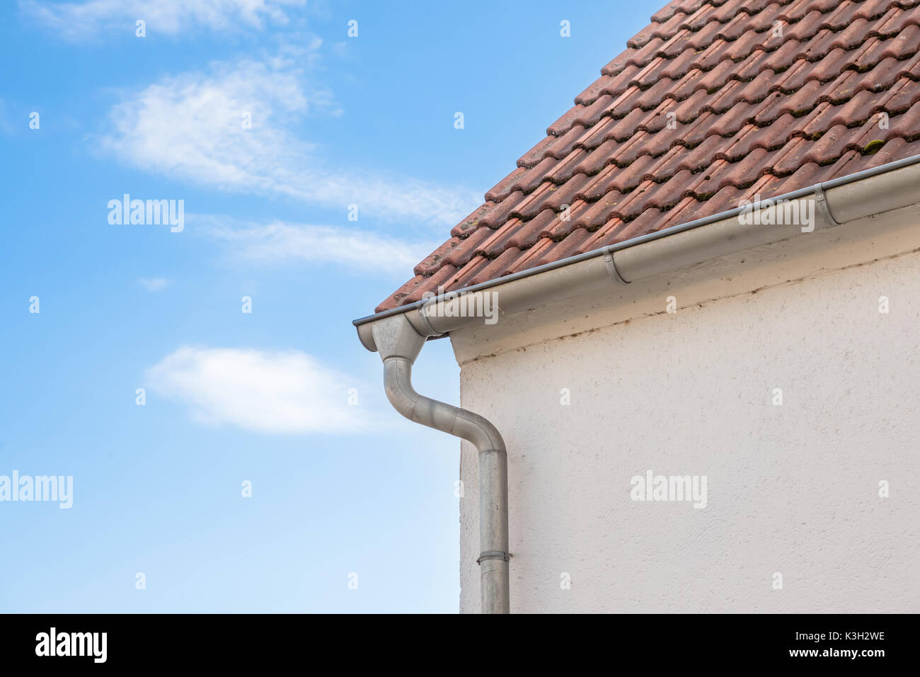 an rain drain pipe from the roof whit blue sky and clouds Stock Photo ...