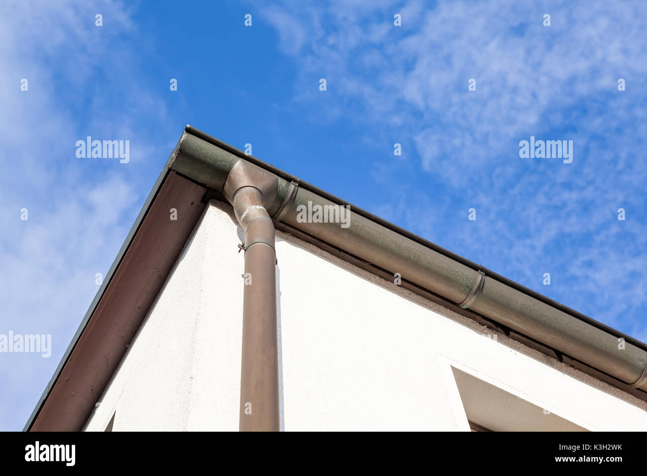 an rain drain pipe from the roof whit blue sky and clouds Stock Photo ...