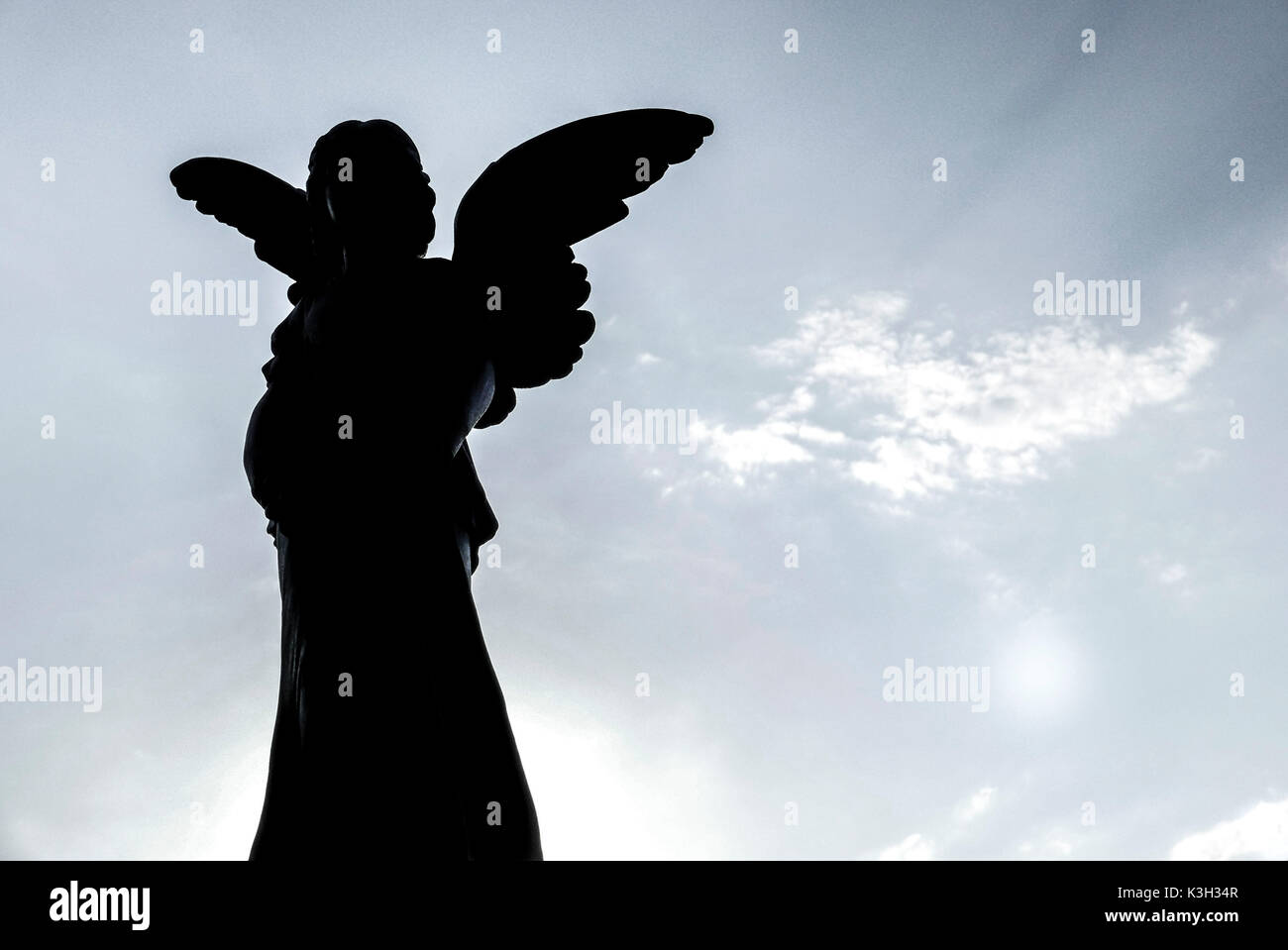Tomb, angel at the back light Stock Photo - Alamy