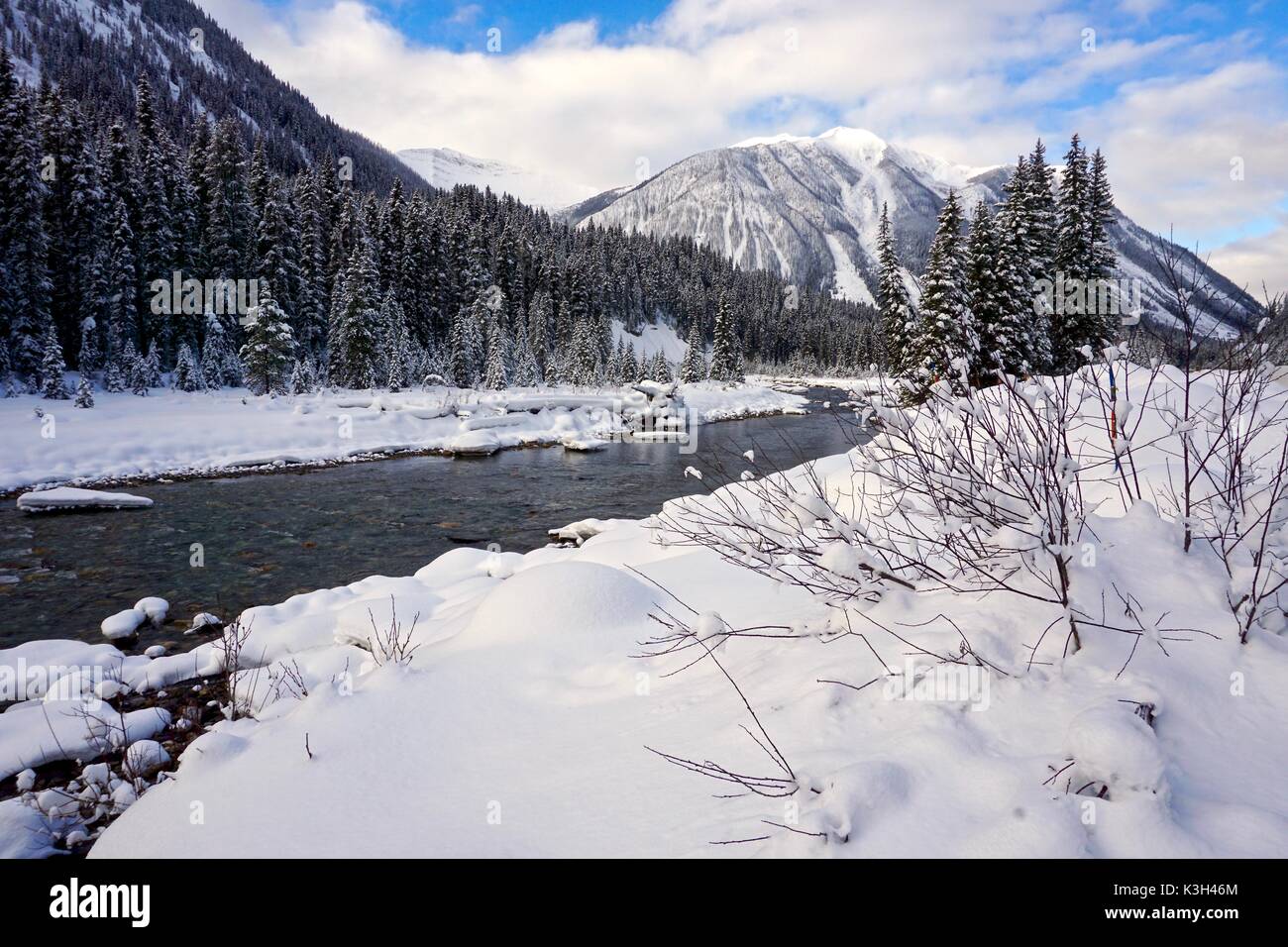 Landscape of snow covered mountains and river stream Stock Photo - Alamy
