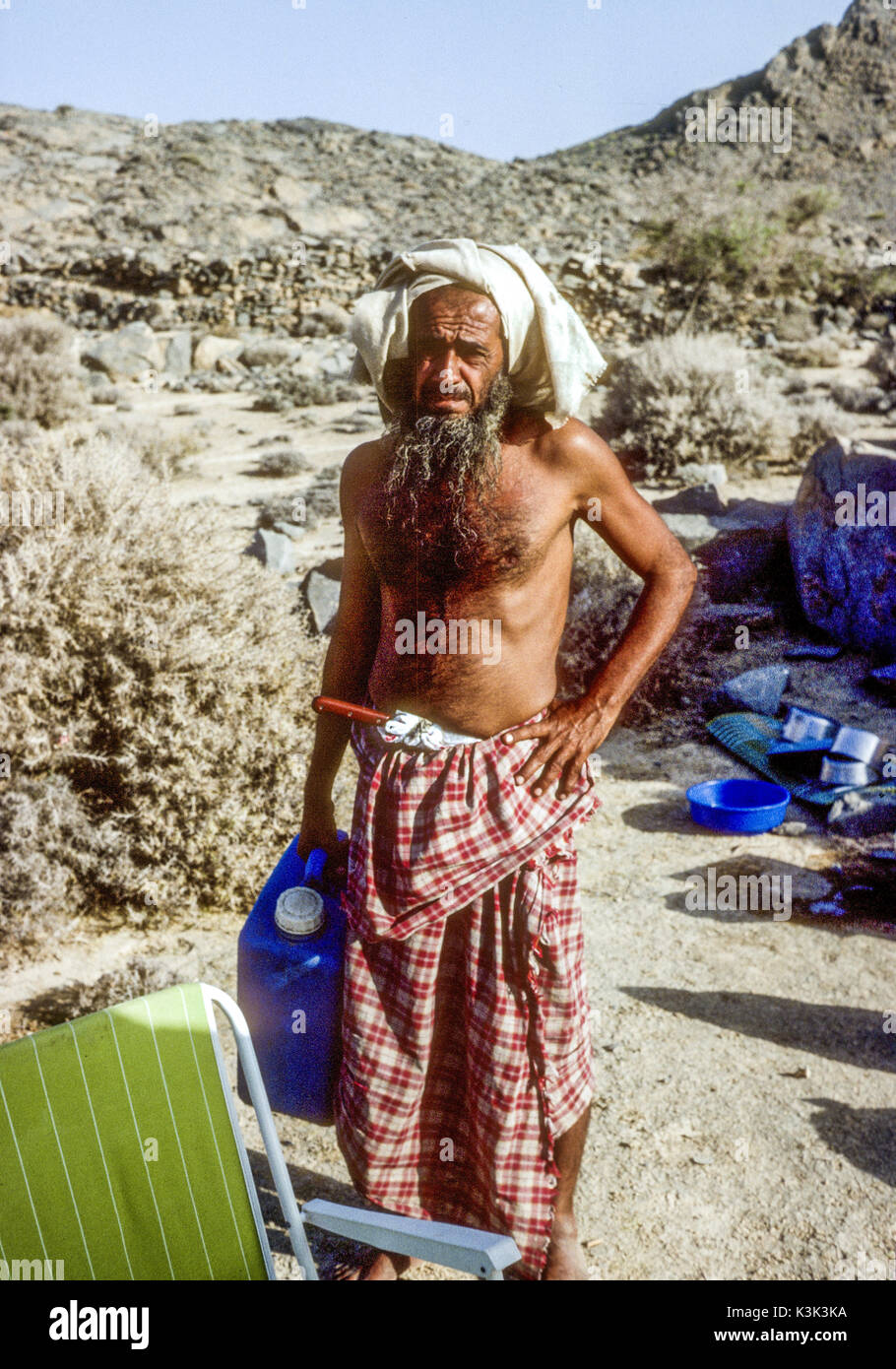 A lone Shihuh villager emerges from barren, rocky scrublands on the ...