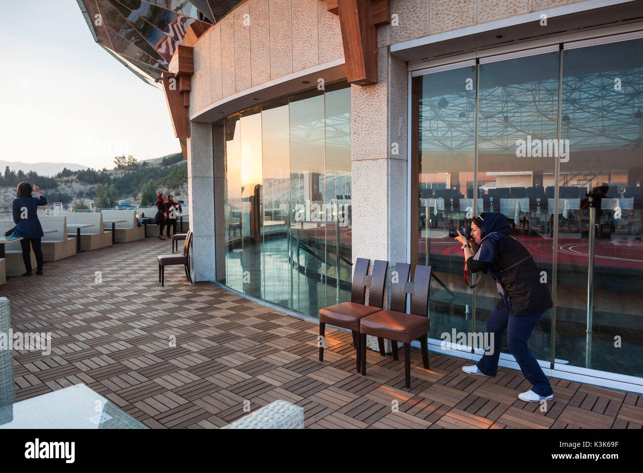 Young iranian woman photographing on hotel balcony hi-res stock ...