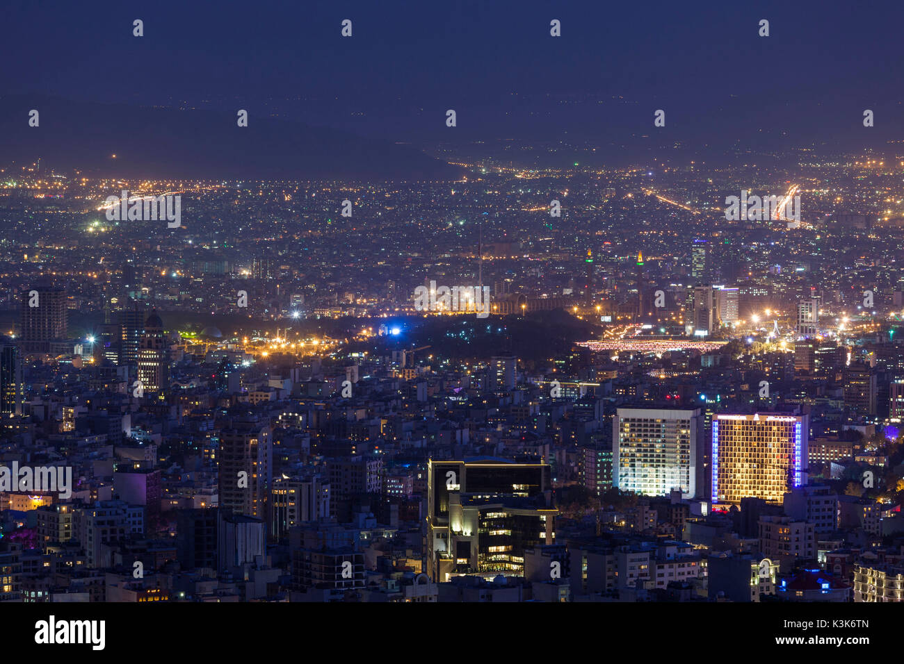 Iran, Tehran, elevated city skyline from the Roof of Iran Park, dusk ...