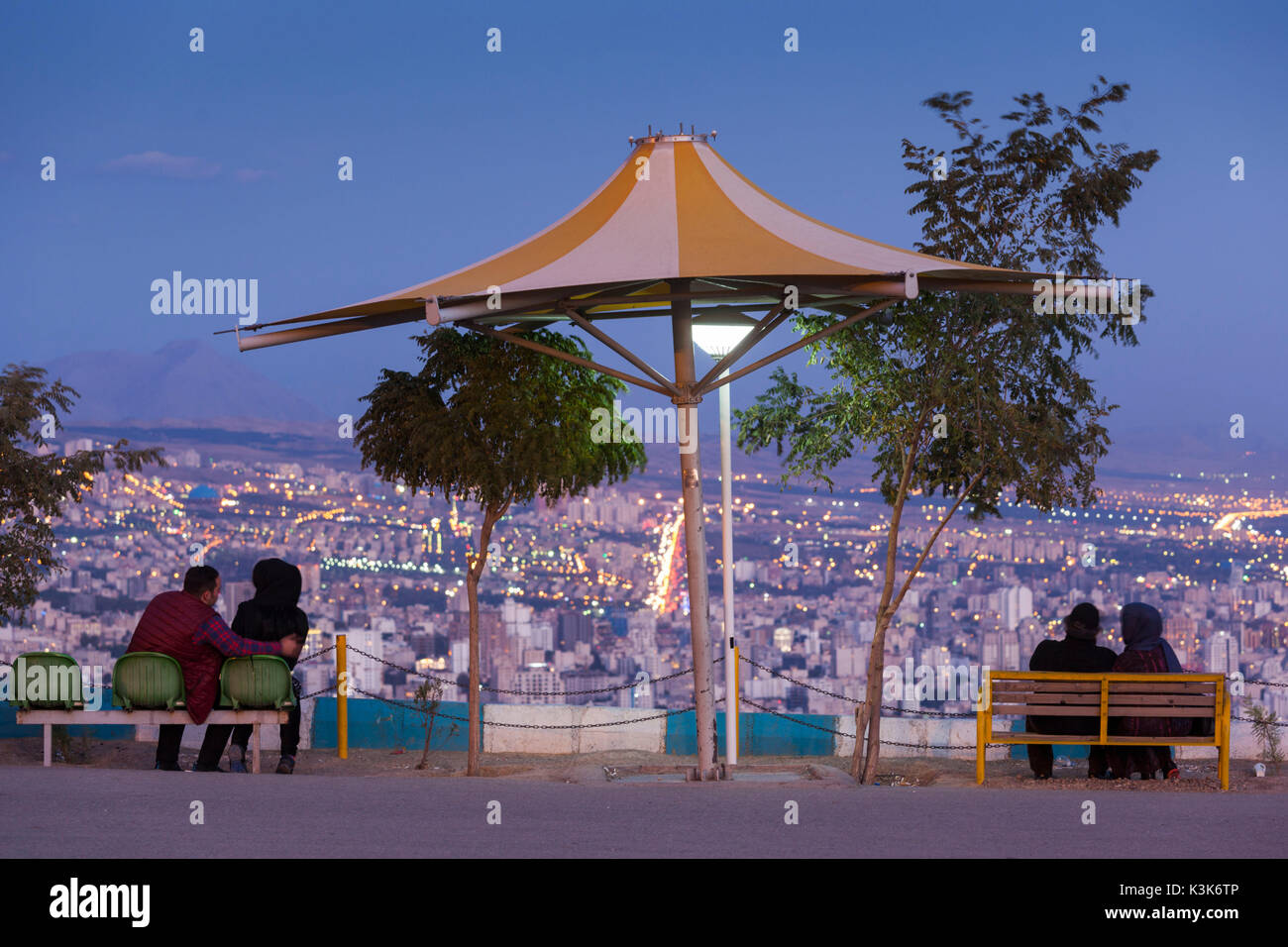 Iran, Tehran, visitors to the Roof of Iran Park above the city skyline ...