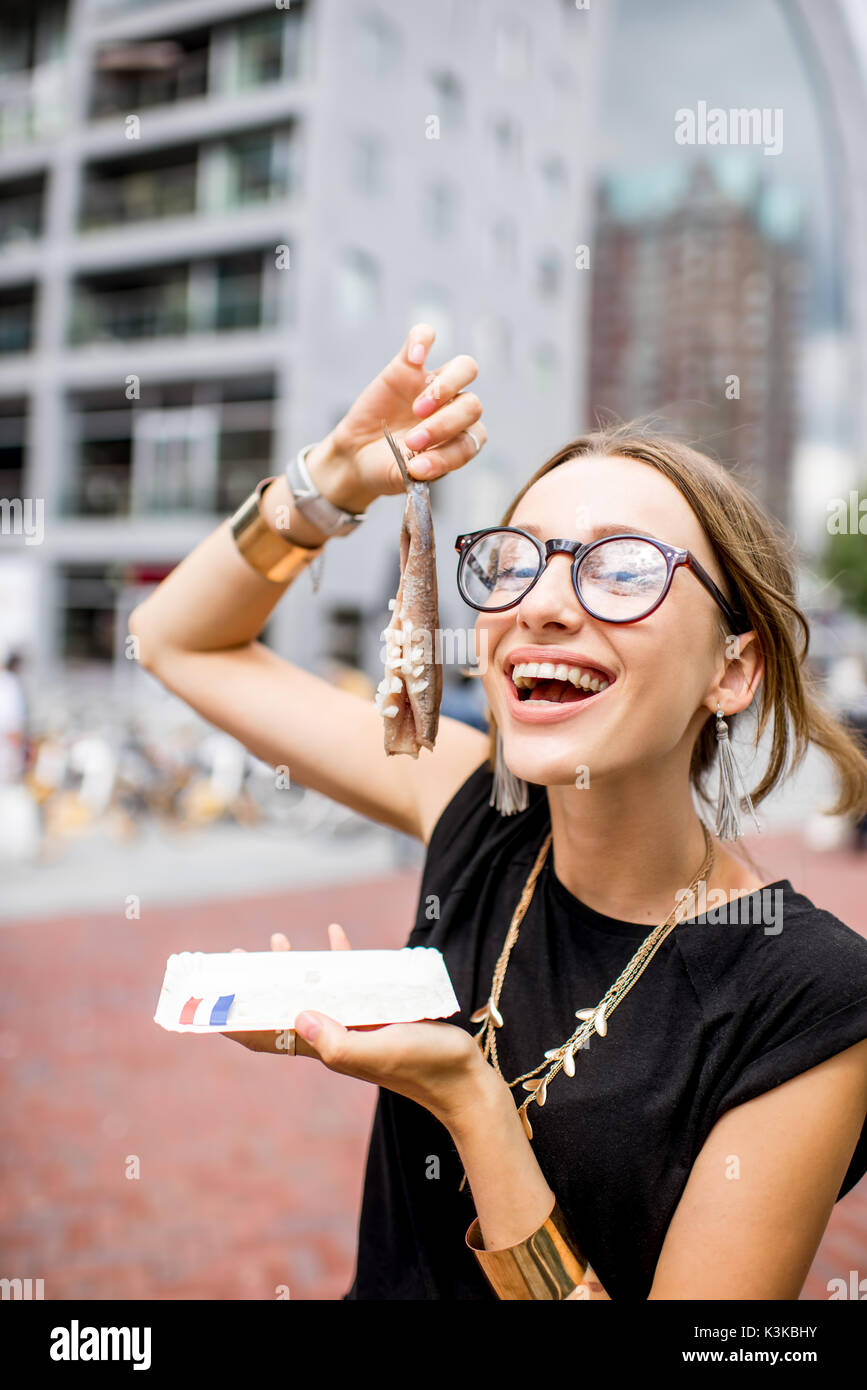 Woman with dutch herring Stock Photo - Alamy