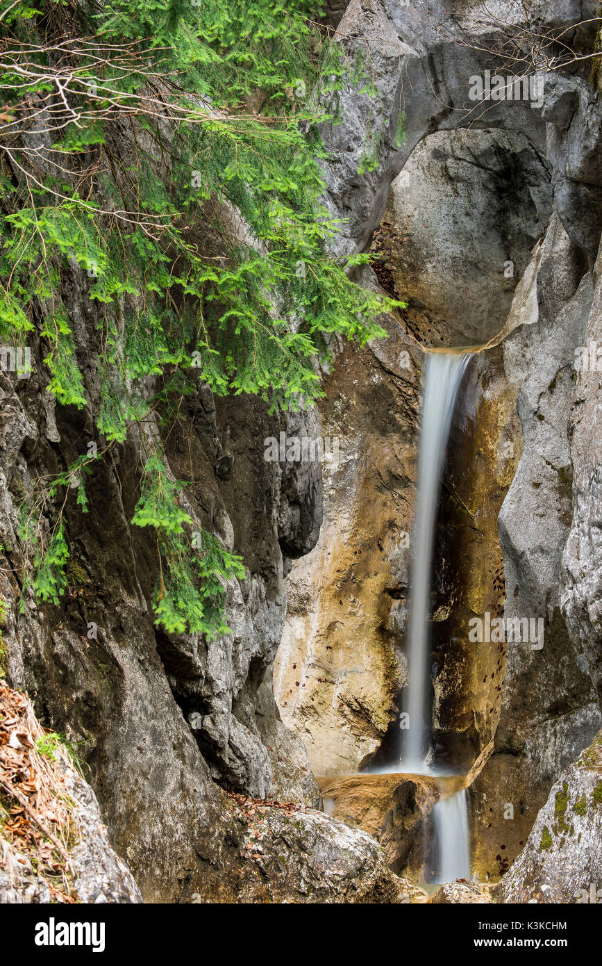 A small watercourse has worked a hole by the rock Stock Photo - Alamy