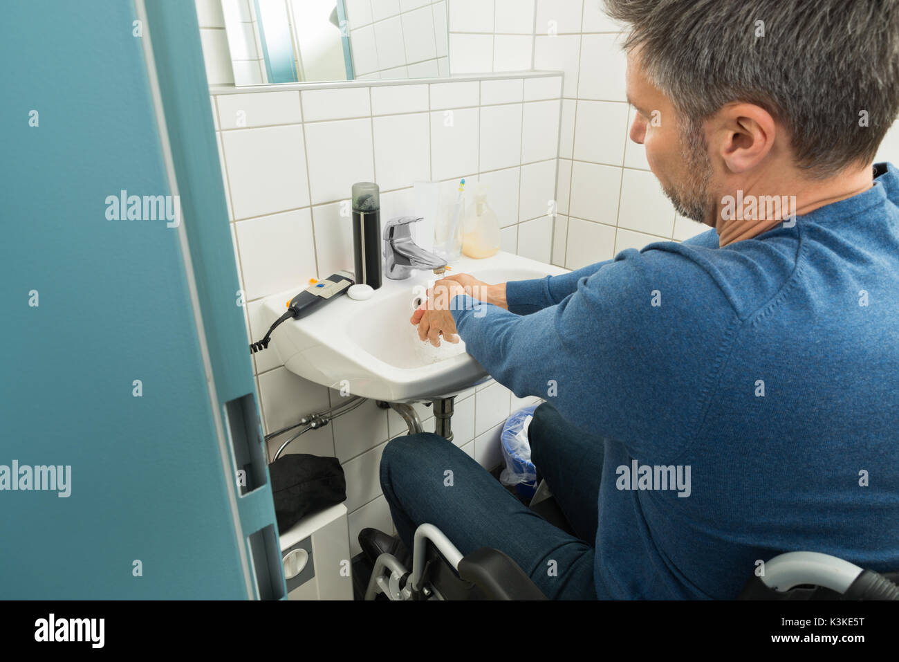 Disabled man in bathroom washing hi-res stock photography and images ...