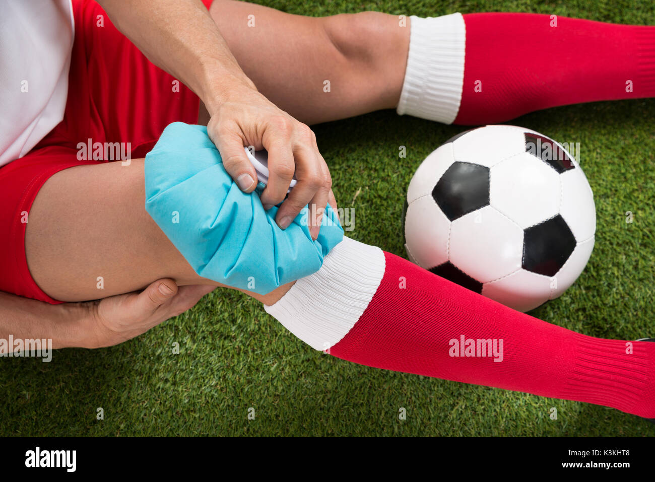 Close-up Of A Soccer Player Icing Knee With Ice Pack On Field Stock ...