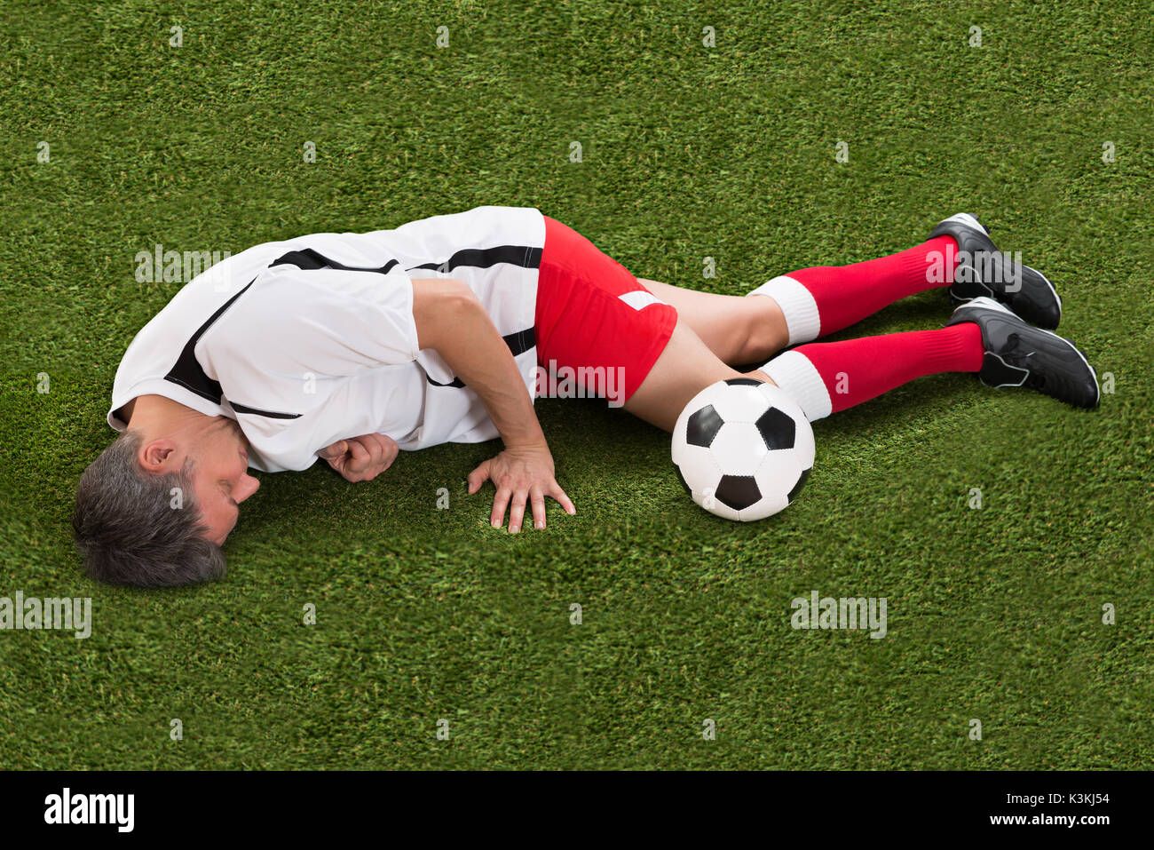 Footballer lying injured hi-res stock photography and images - Alamy