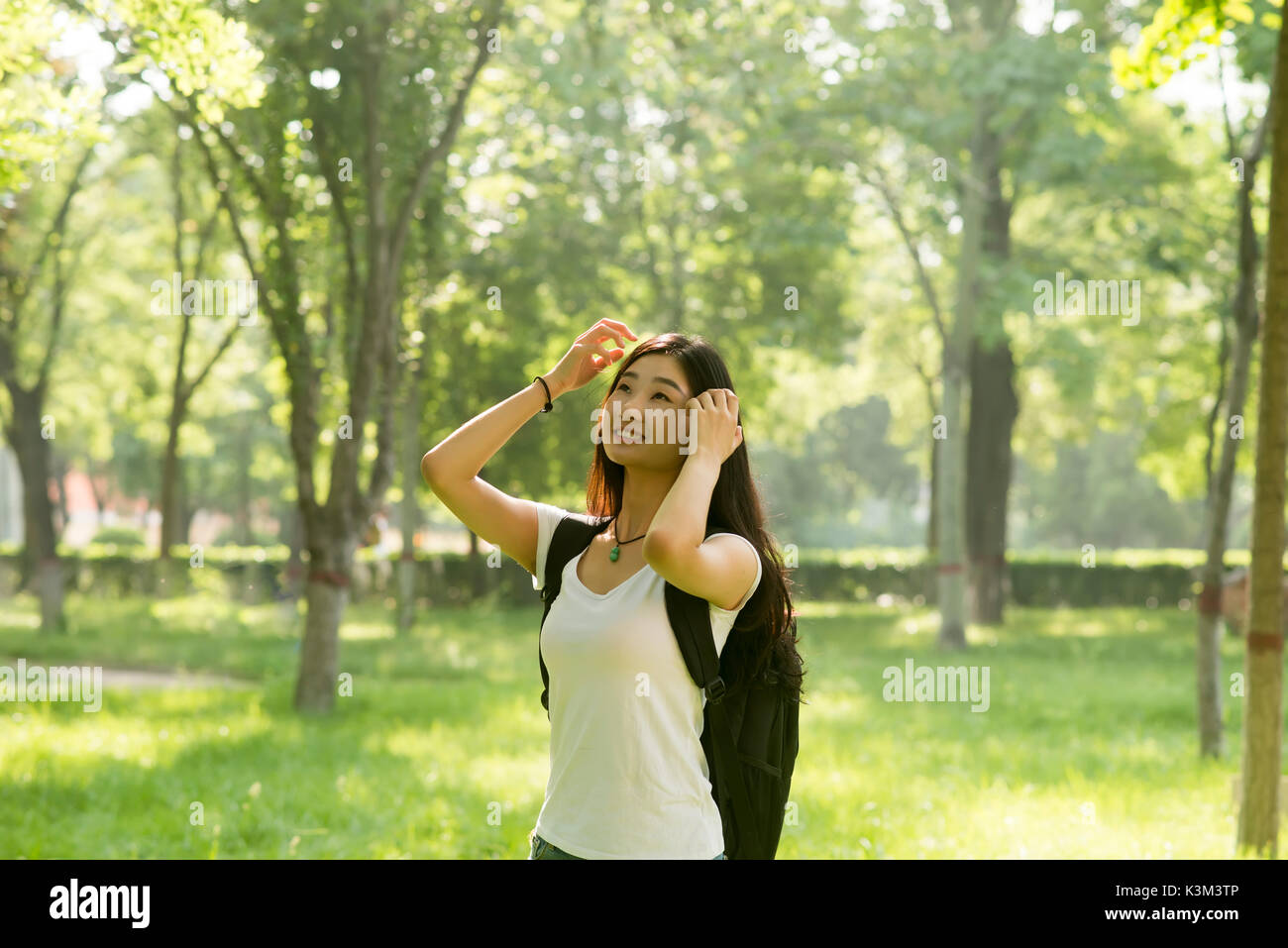Girl basking in the sun on the grove Stock Photo - Alamy