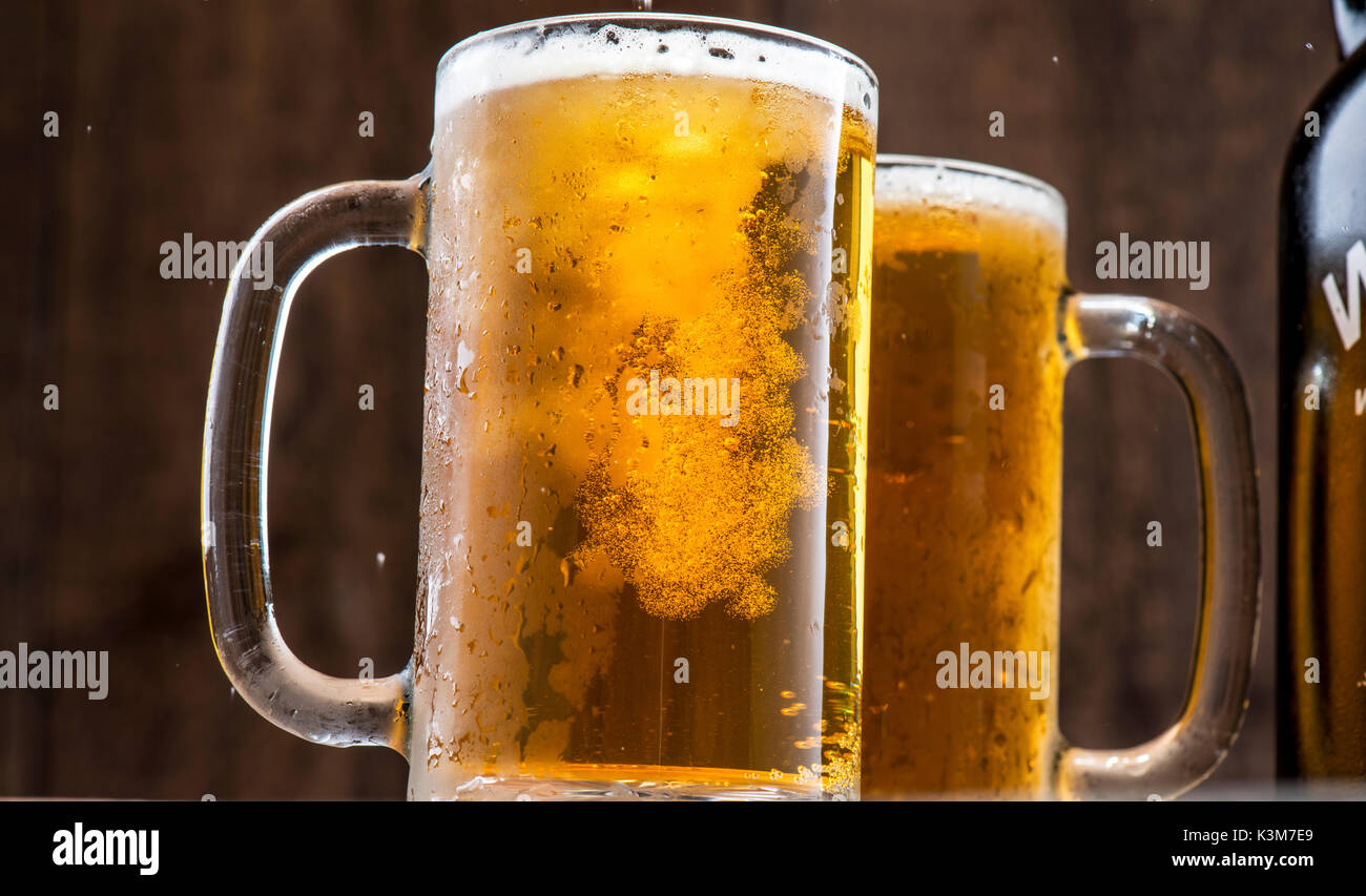 cold beer on mugs Stock Photo - Alamy